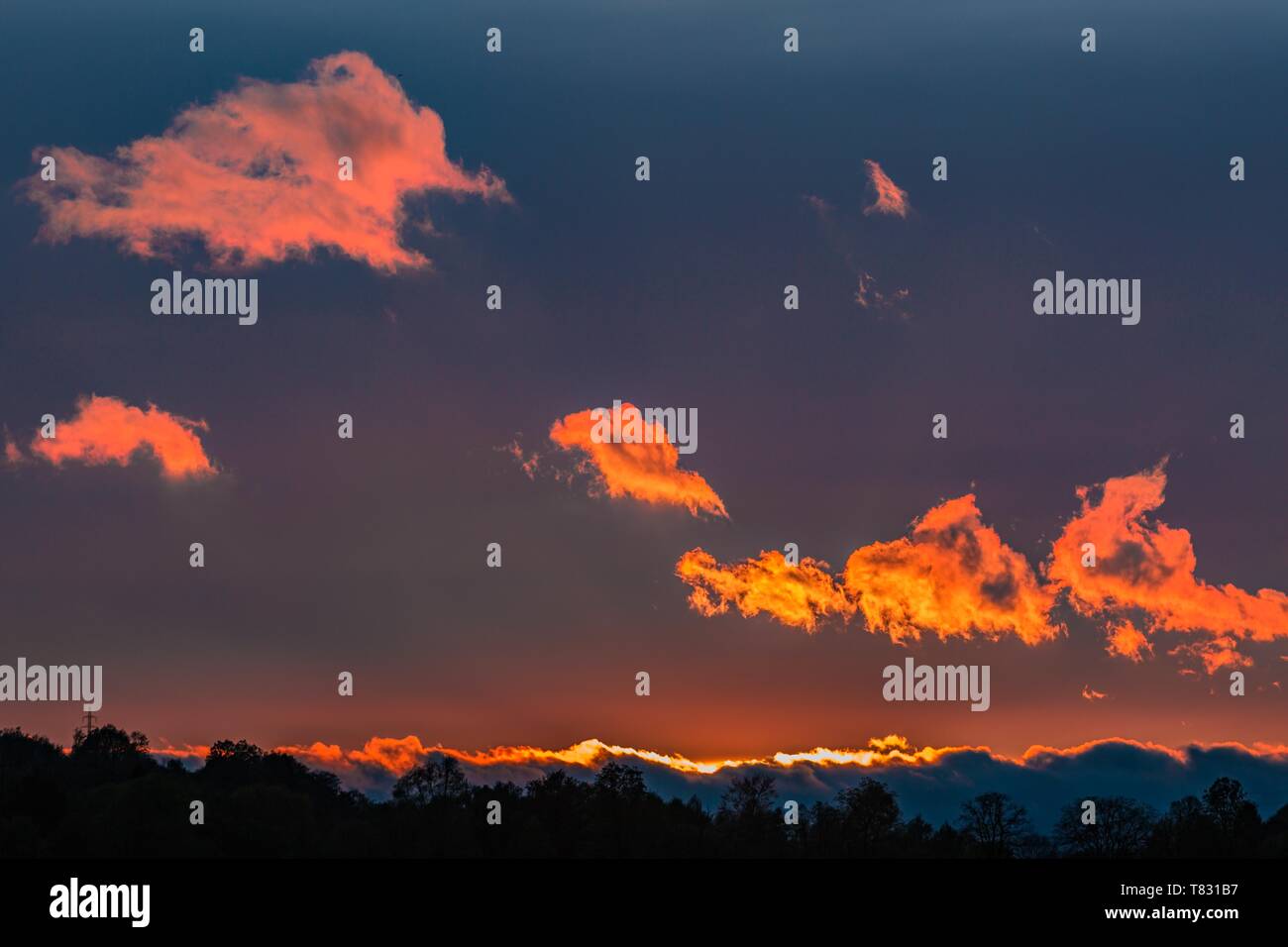Dramatic dark blue sky with pink, orange, red and golden clouds during ...