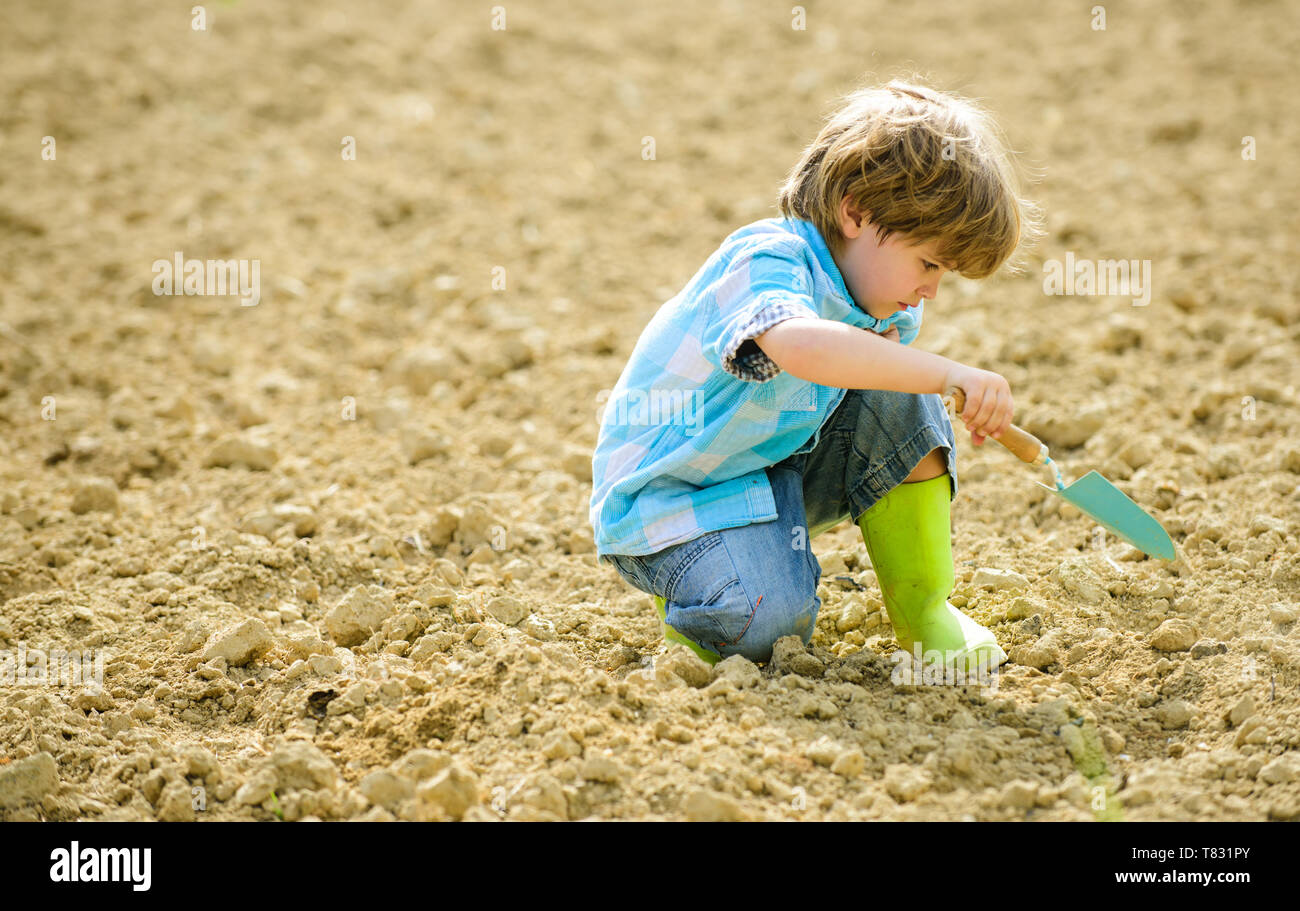 farming and agriculture. small kid planting a flower. ecology life ...