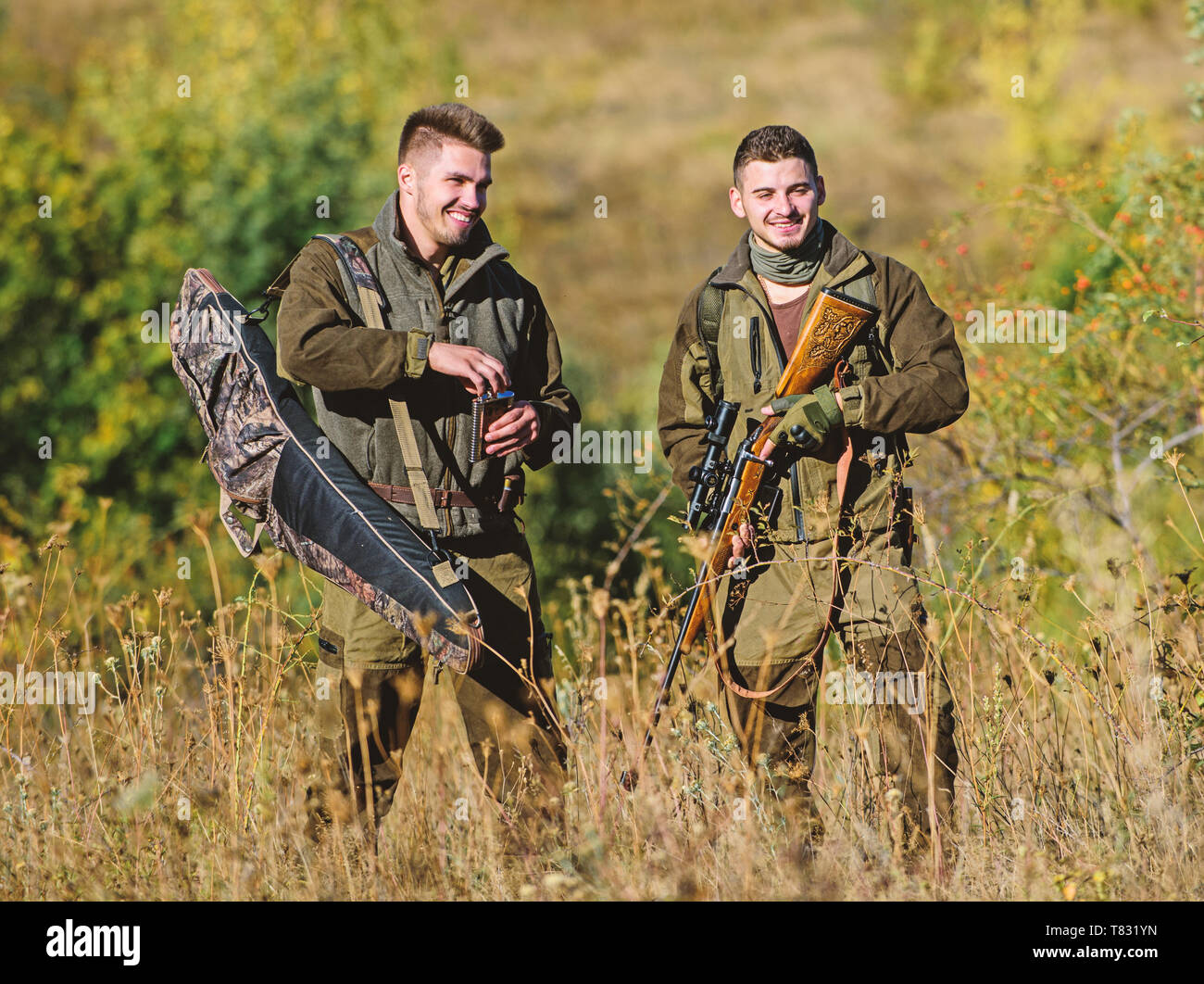 Man hunters with rifle gun. Boot camp. Hunting skills and weapon ...