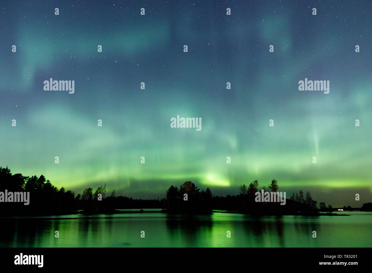 Beautiful northern lights over lake Stock Photo - Alamy