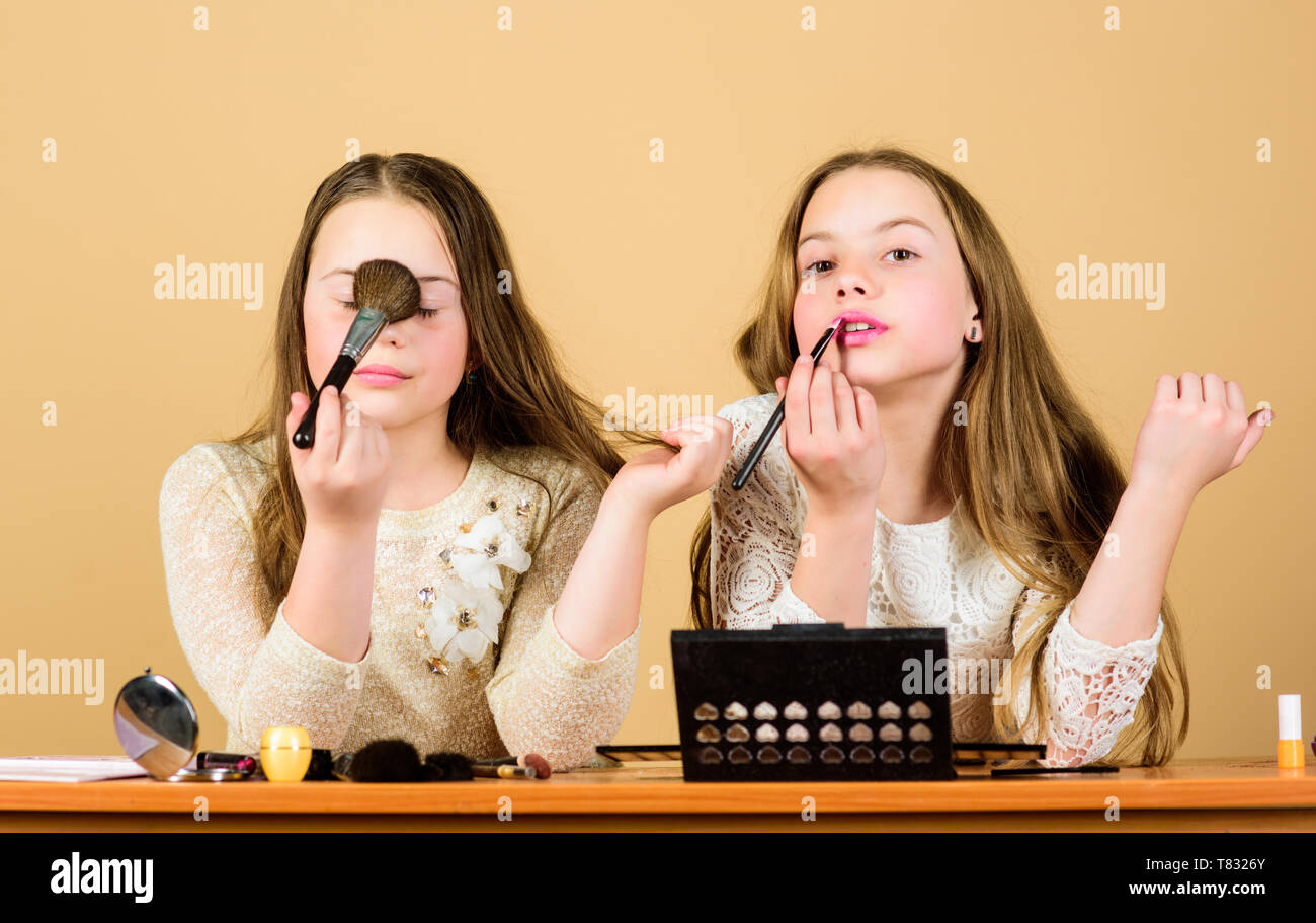 Experts in cosmetics. Cute beauty models wearing facial cosmetics ...