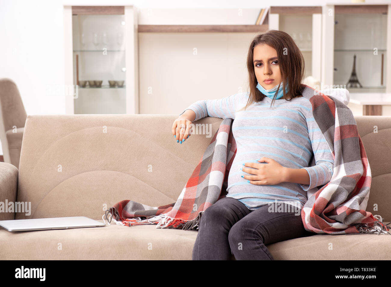 Sick pregnant woman suffering at home Stock Photo - Alamy