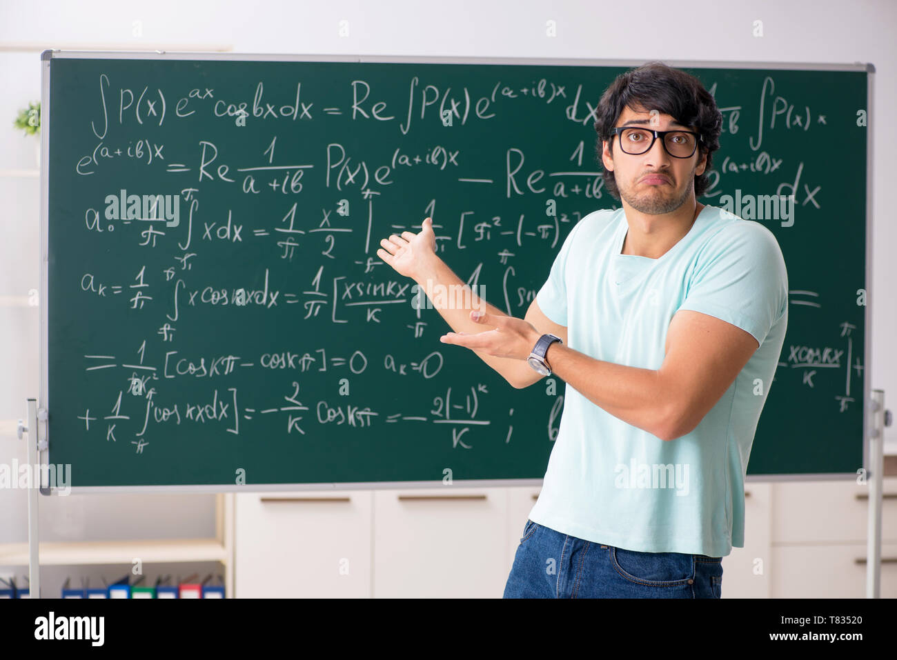 Young male student mathematician in front of chalkboard Stock Photo - Alamy