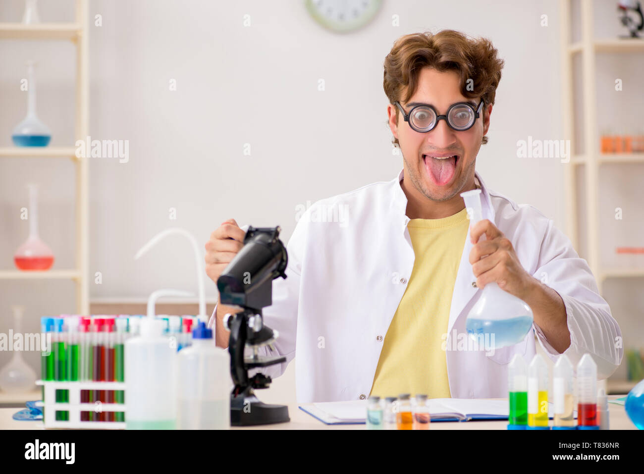 Funny crazy chemist doing experiments and tests Stock Photo - Alamy