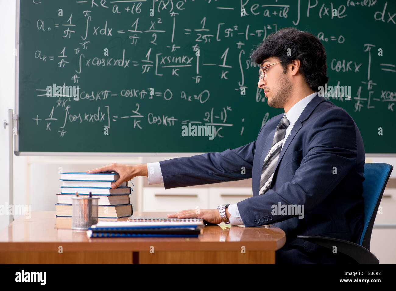 Young male math teacher in classroom Stock Photo - Alamy