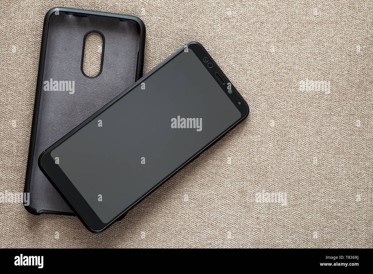 New black modern cellphone and plastic protective case isolated on ...