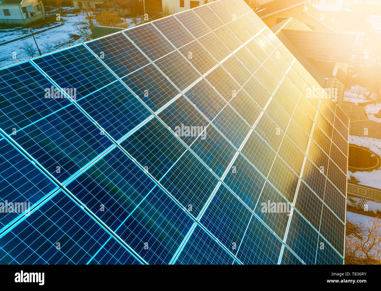 Close-up surface of lit by sun blue shiny solar photo voltaic panels ...