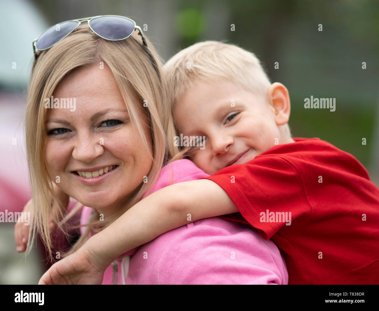 Portrait of a happy mother and son smiling outdoors Stock Photo - Alamy