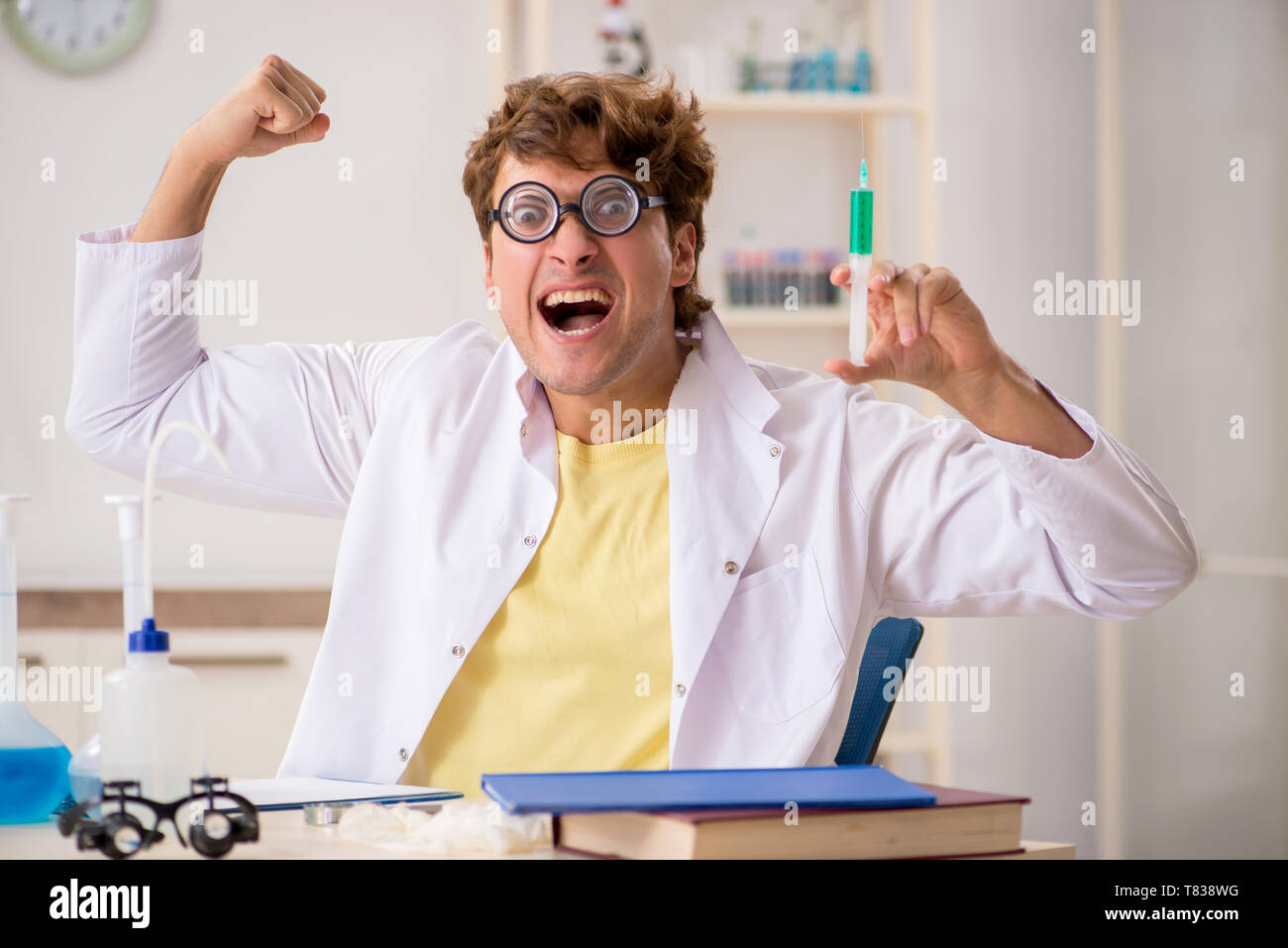 Funny crazy chemist doing experiments and tests Stock Photo - Alamy