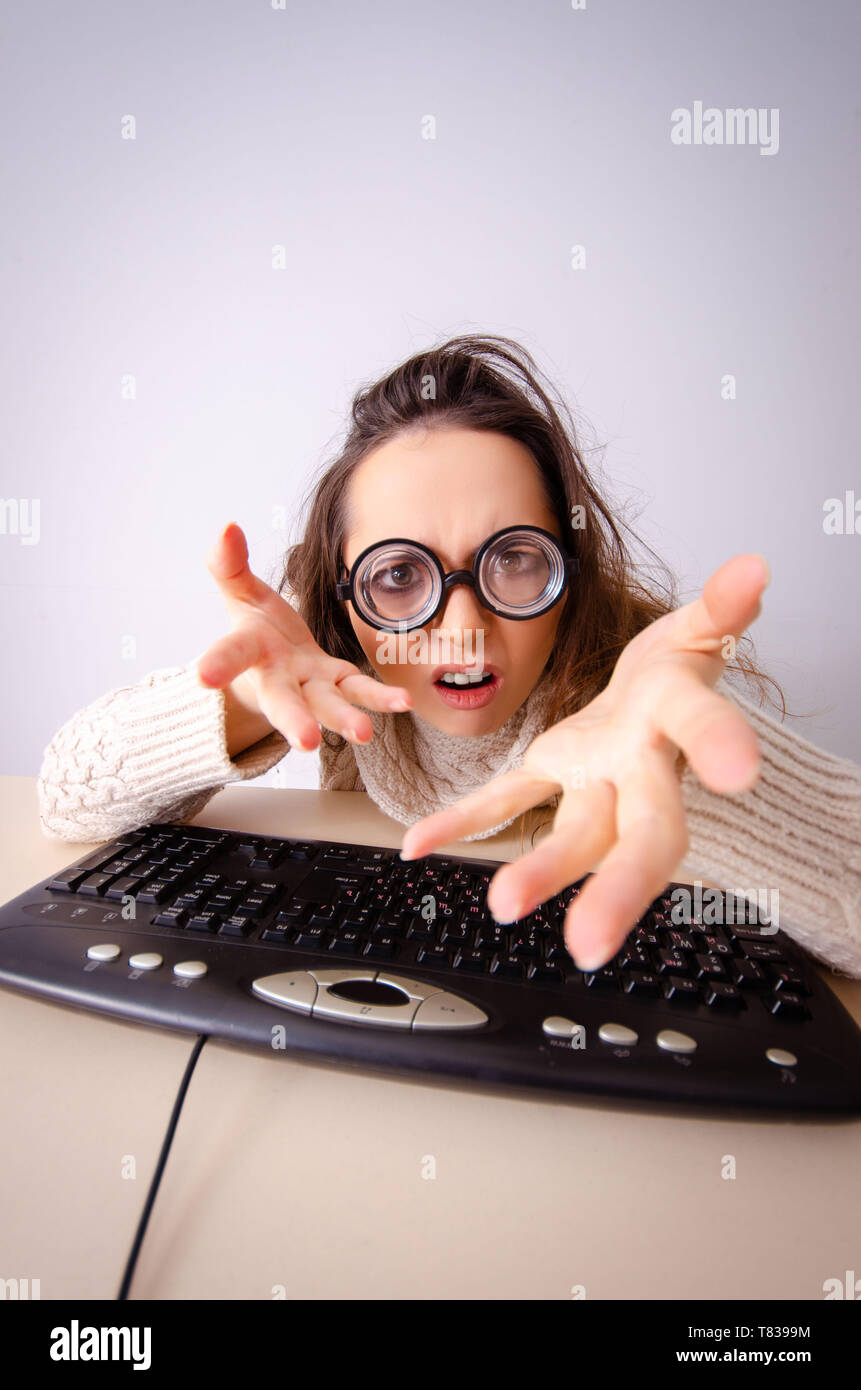 Funny nerd girl working on computer Stock Photo - Alamy