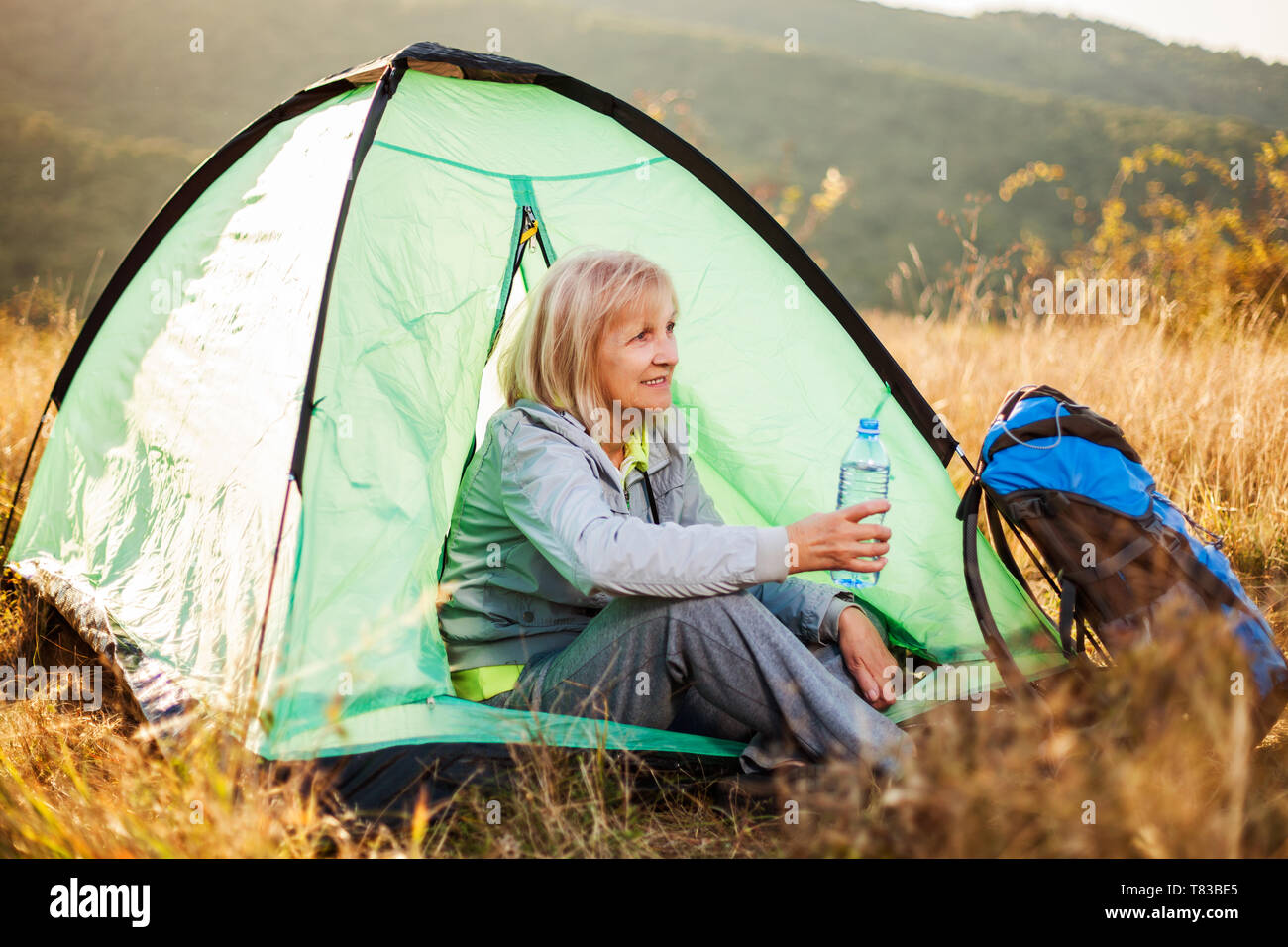 Senior woman is camping in mountain. Active retirement Stock Photo - Alamy