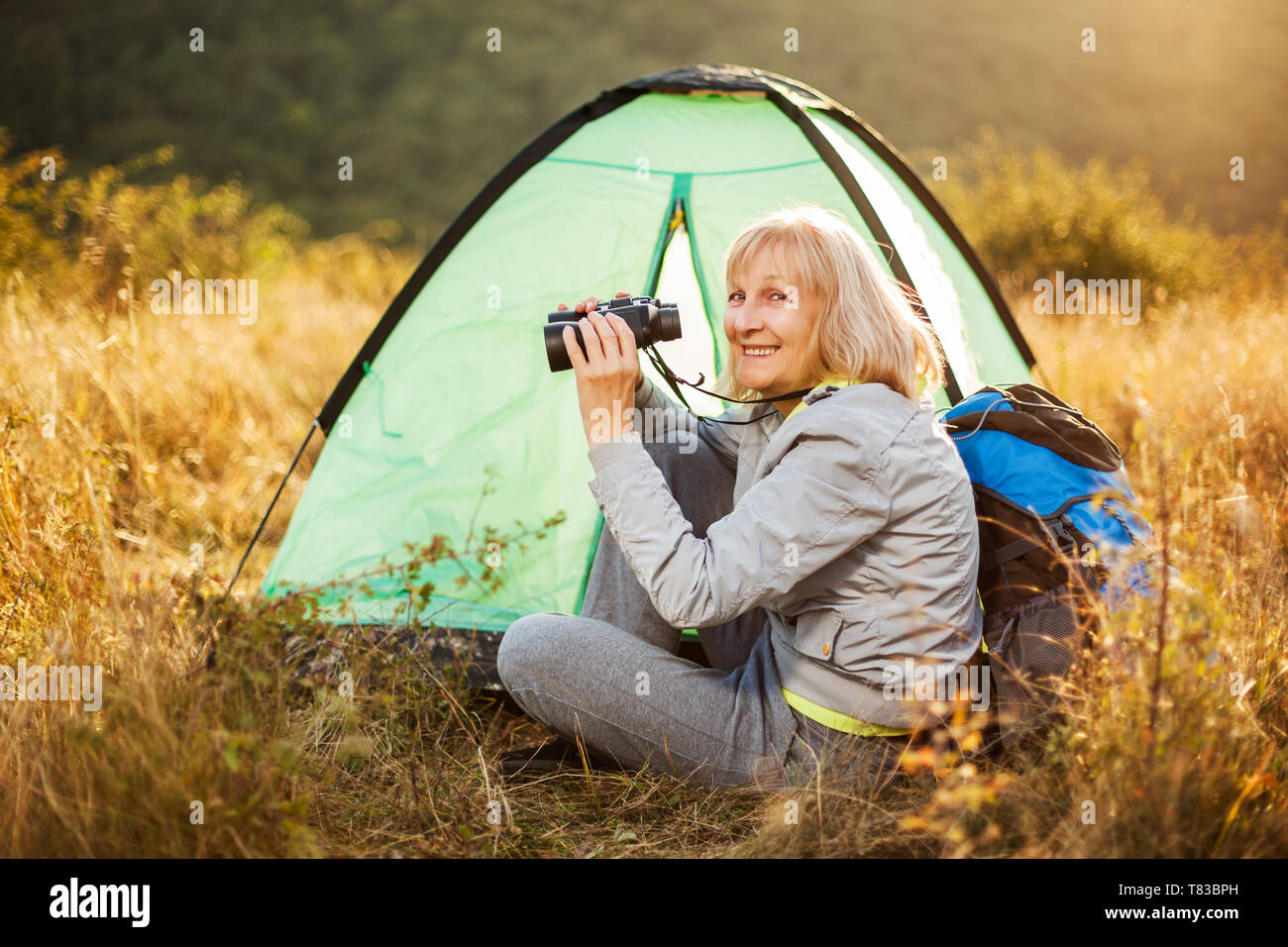 Senior woman is camping in mountain. Active retirement Stock Photo - Alamy