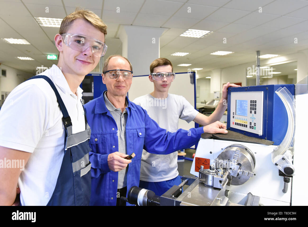 Group of young people in technical vocational training with teacher ...