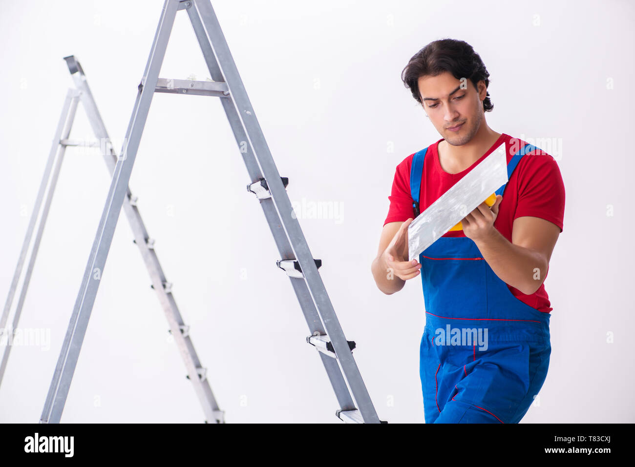 Young handsome contractor working indoors Stock Photo - Alamy
