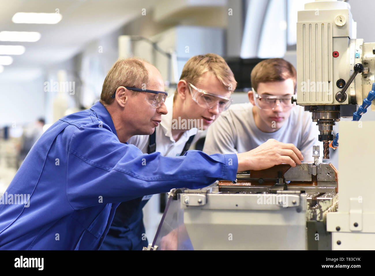 Group of young people in technical vocational training with teacher ...