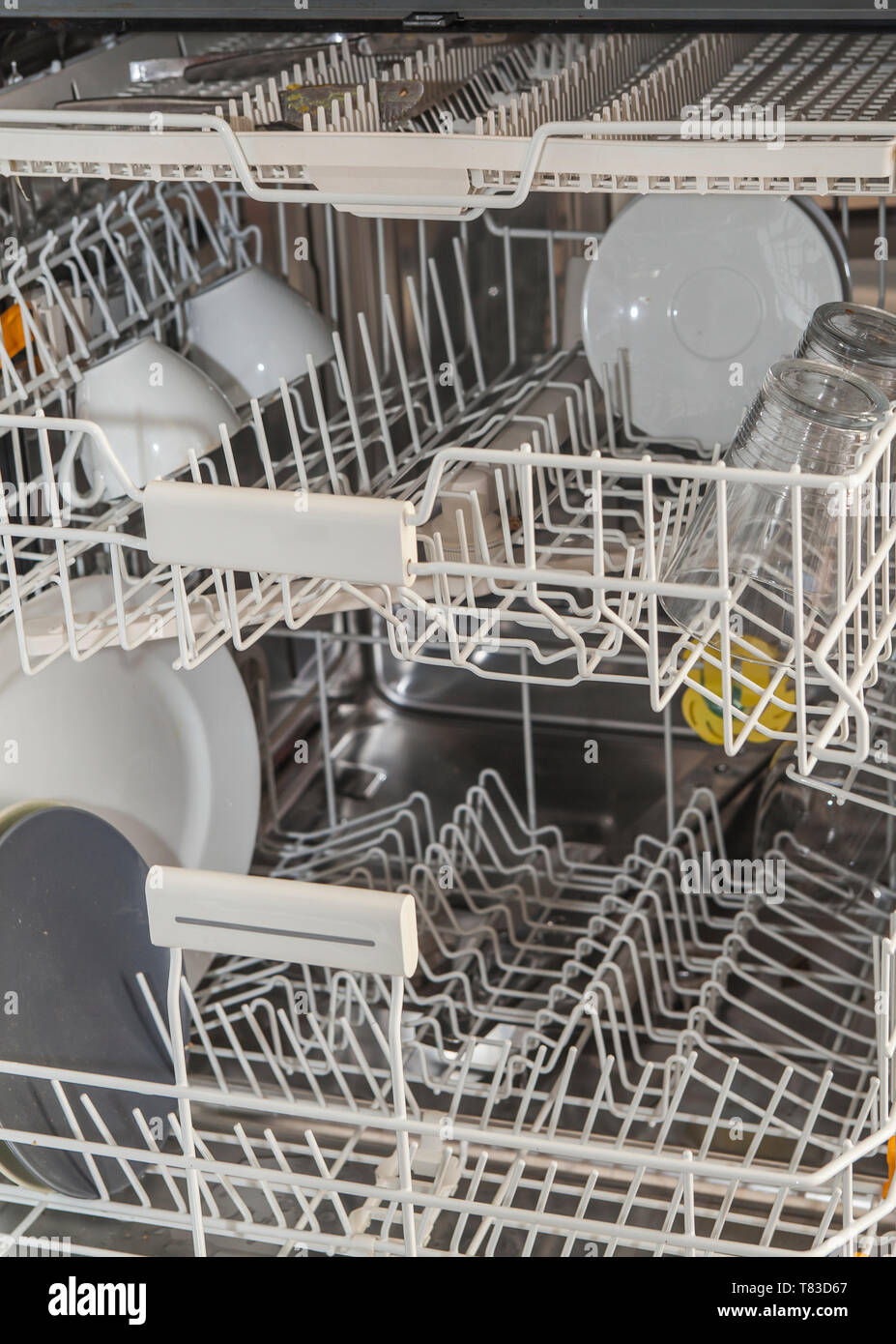 Interior of almost empty dishwasher Stock Photo - Alamy