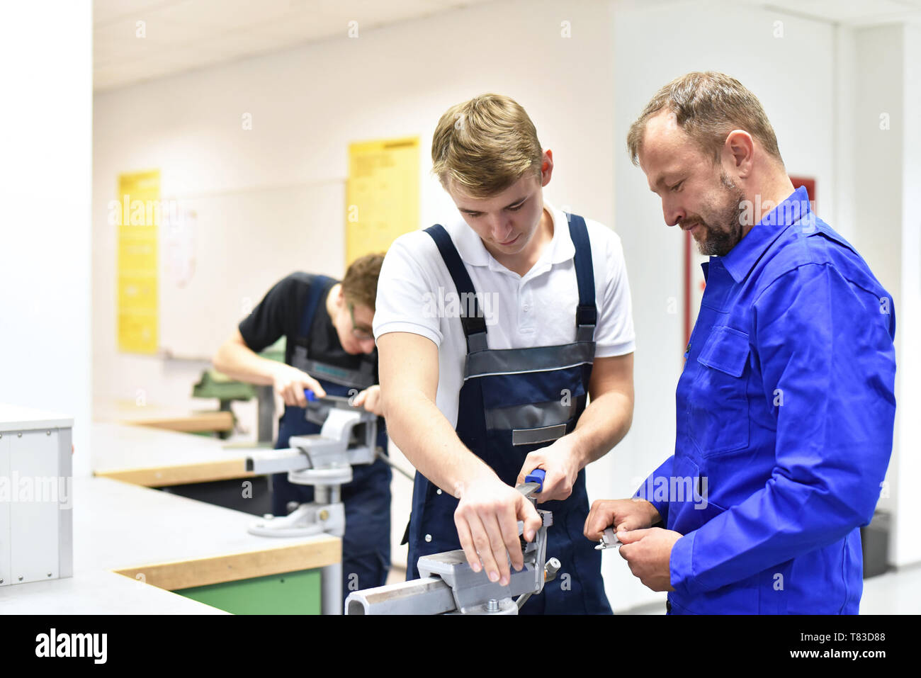 Group of young people in technical vocational training with teacher ...