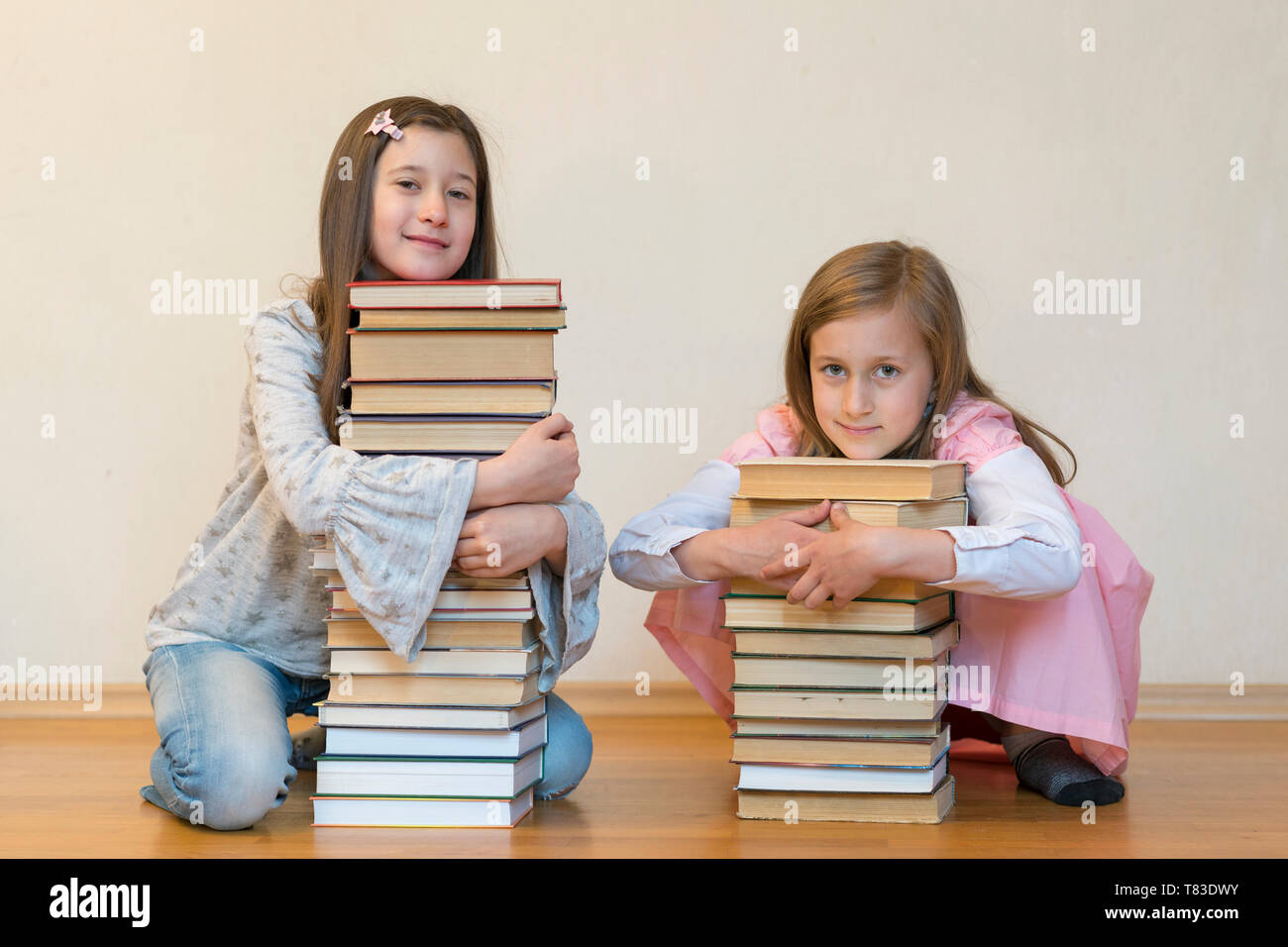 Two kids pile books hi-res stock photography and images - Alamy