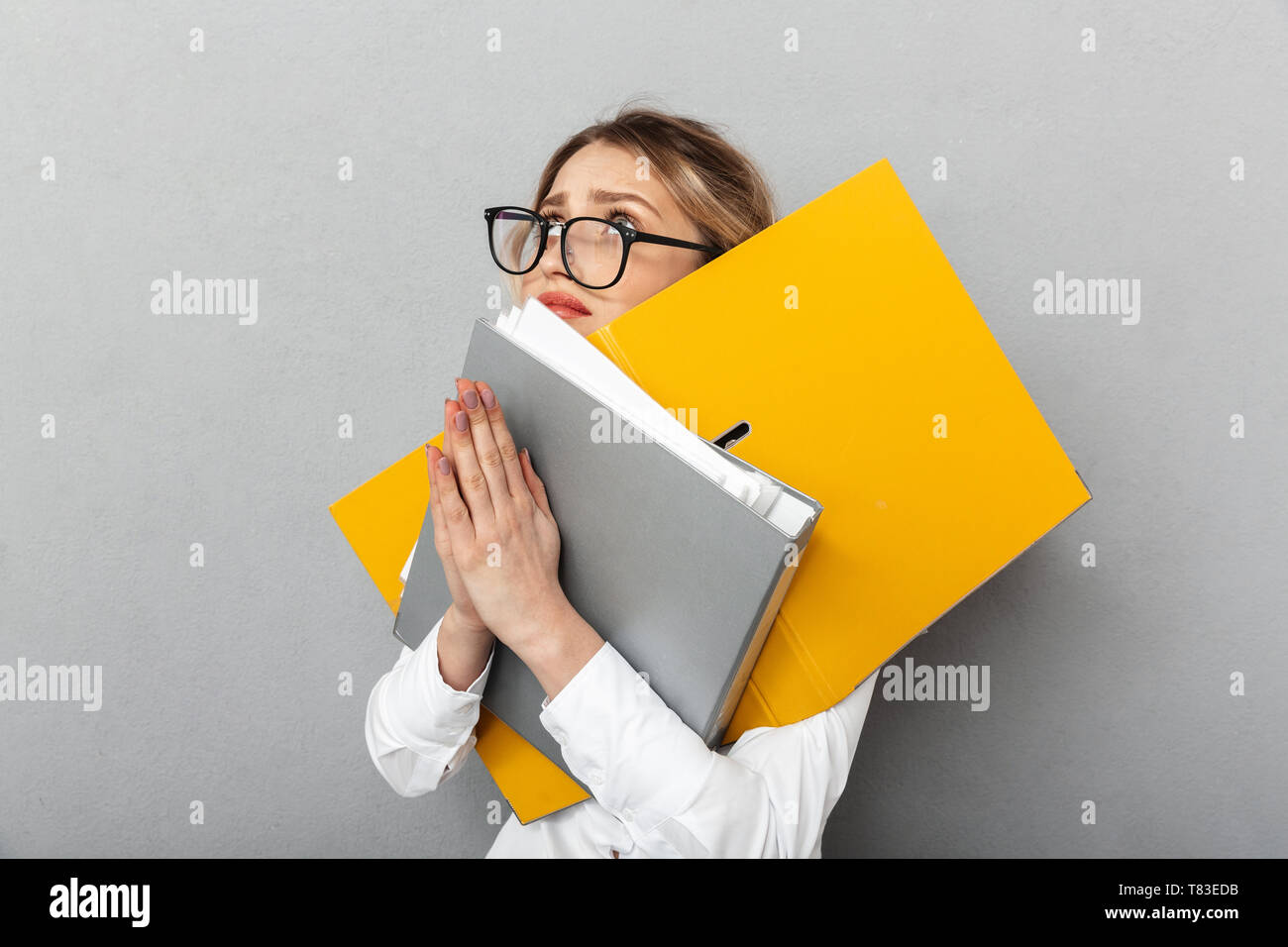 Image of a young confused business woman isolated over grey wall ...