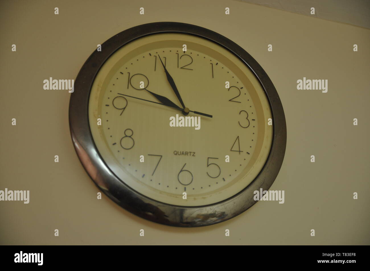 A large round clock hangs on the wall Stock Photo - Alamy
