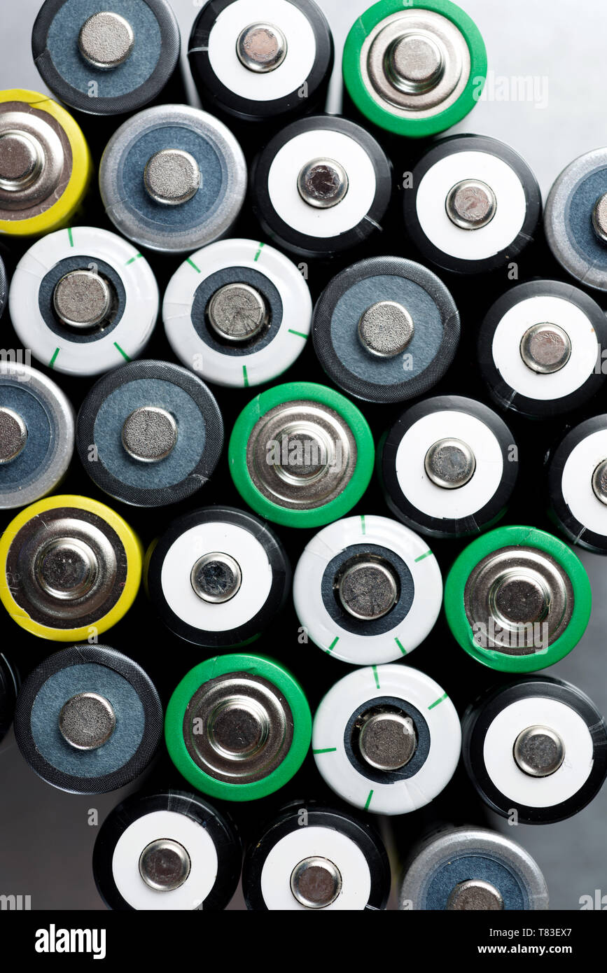 Many batteries on a metal table Stock Photo - Alamy