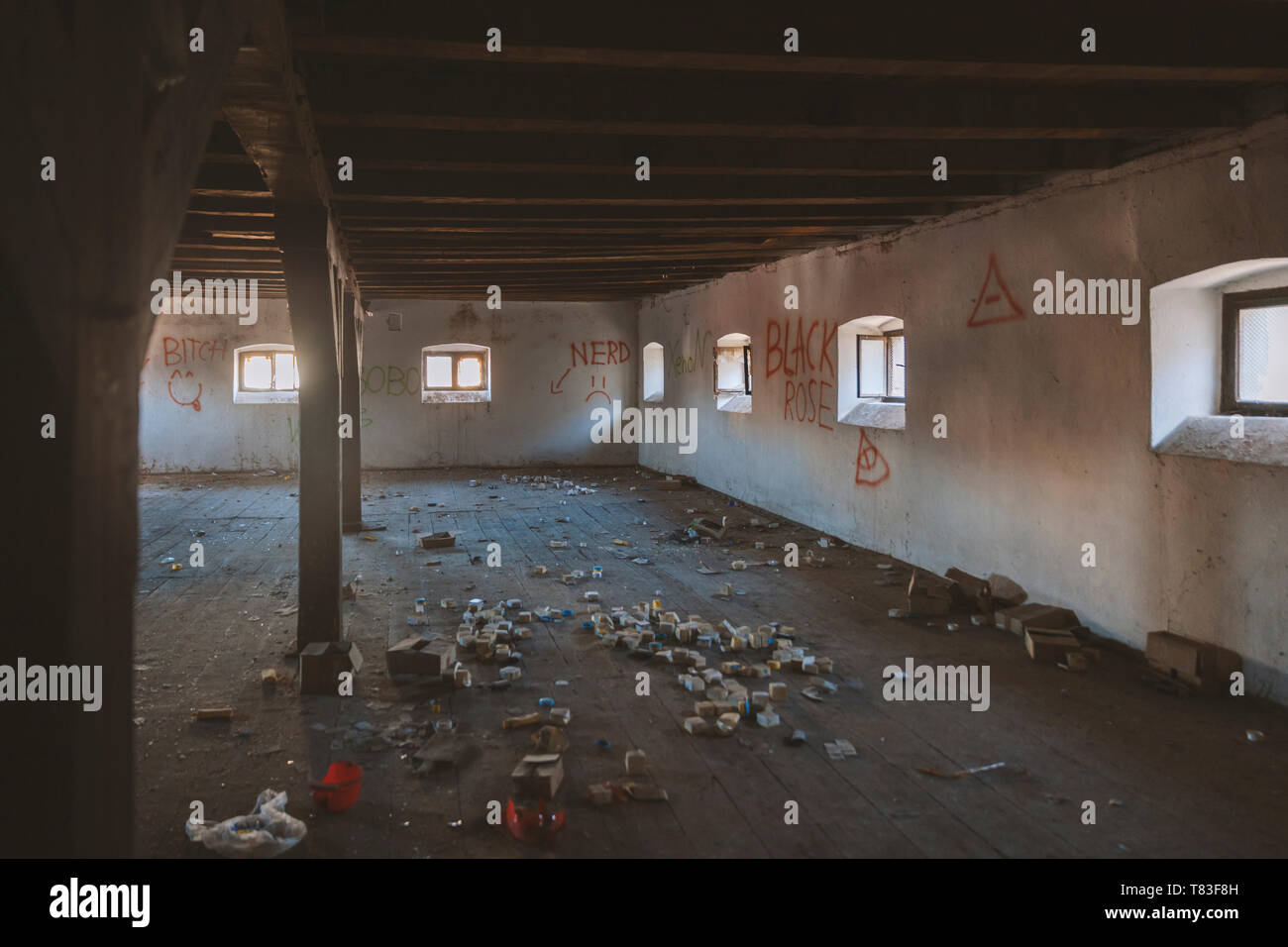 creepy old abandoned warehouse with offensive graffiti on the walls ...