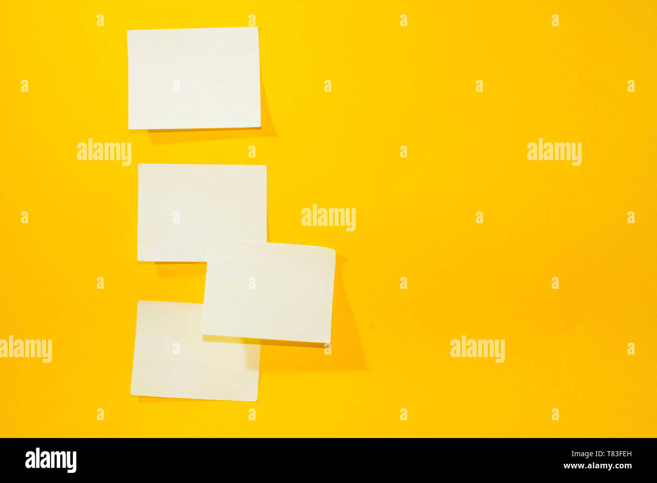Blank yellow square sticky notes on an orange background. Copy space ...