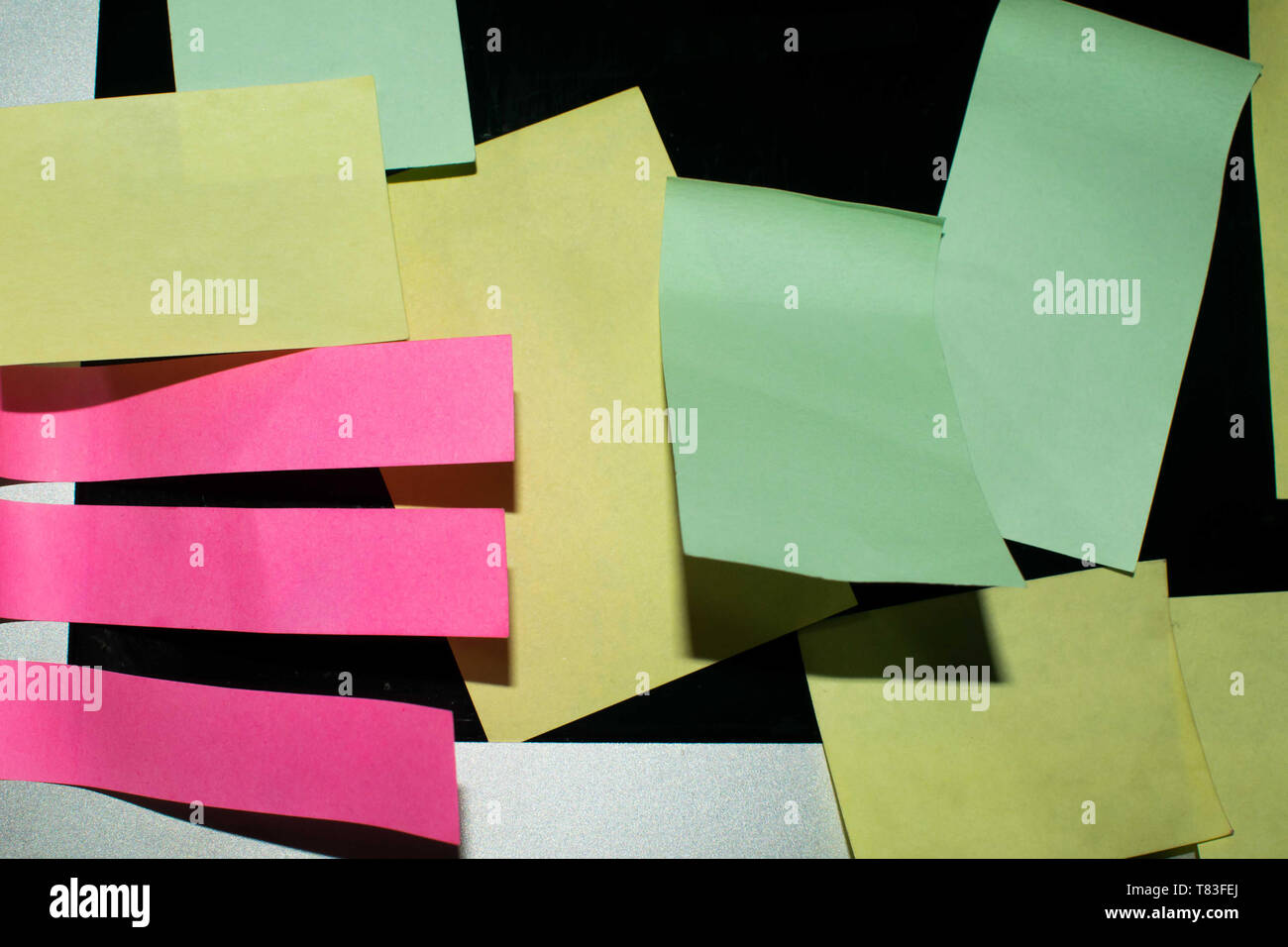 Blank different colored sticky notes taped on a blank laptap screen ...