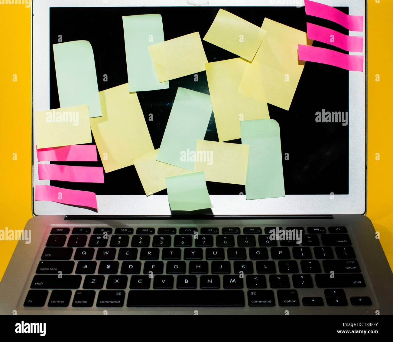 Colourful sticky notes on a blank screen of a laptap Stock Photo - Alamy