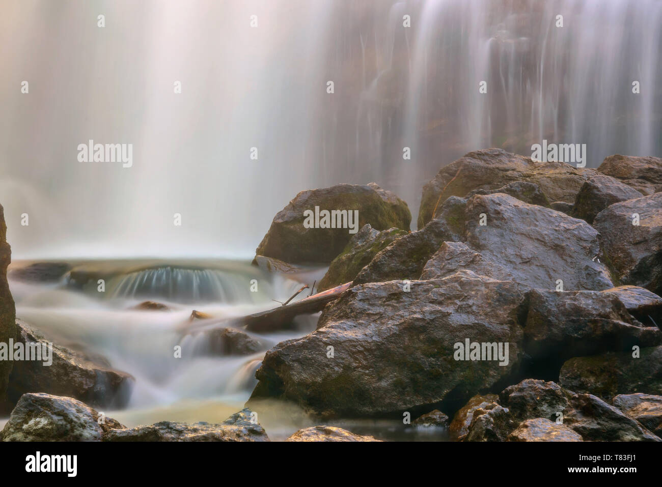 Beautiful waterfall with smooth silky water among rocks and stones ...
