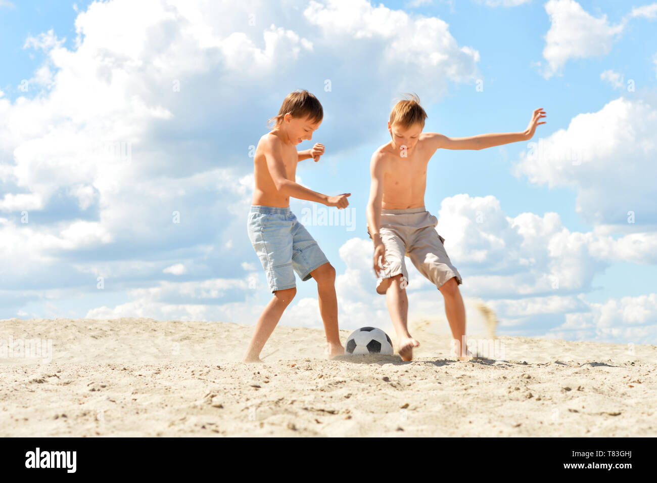 Boys brothers playing football soccer hi-res stock photography and ...