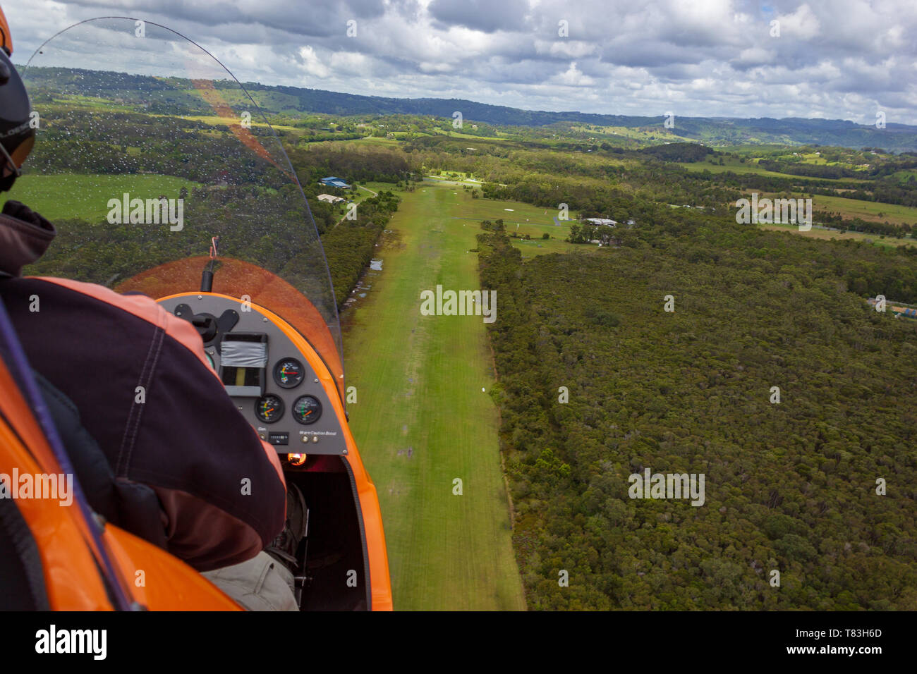 Gyrocopter is landing on an airfield out of gras, Byron Bay, Queensland ...