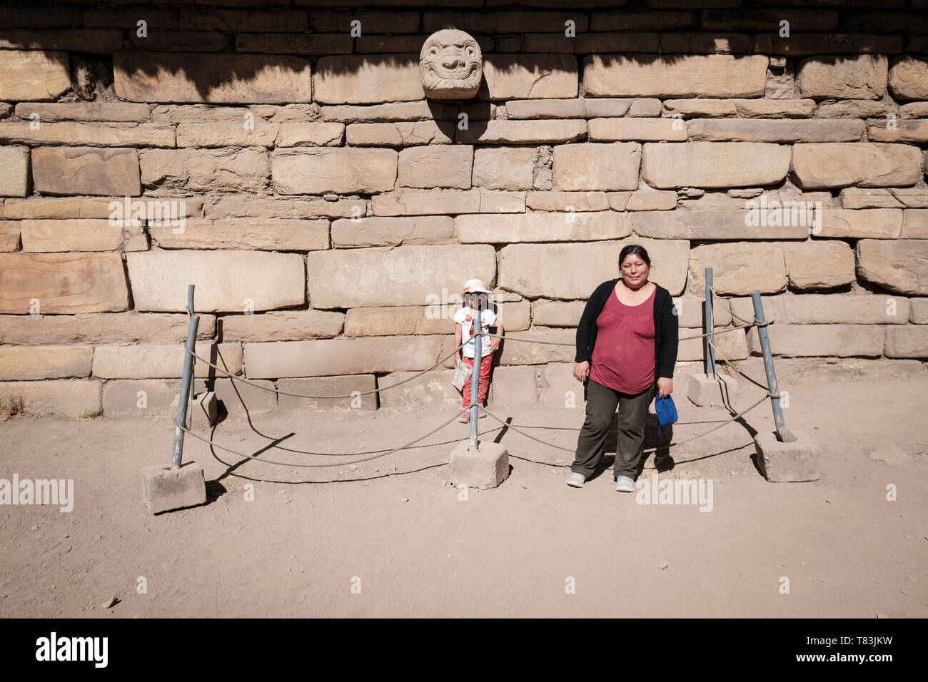 Tourists taking pictures with the ancient stone tenon head or Cabeza ...
