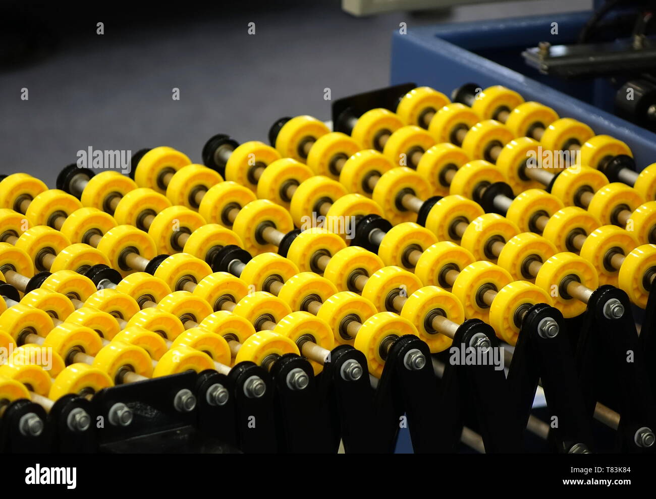 Small yellow plastic rollers for transporting goods Stock Photo - Alamy