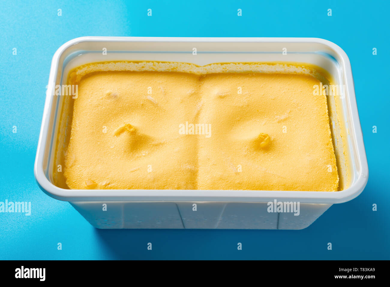 side view box of mango flavor ice cream on blue background Stock Photo ...