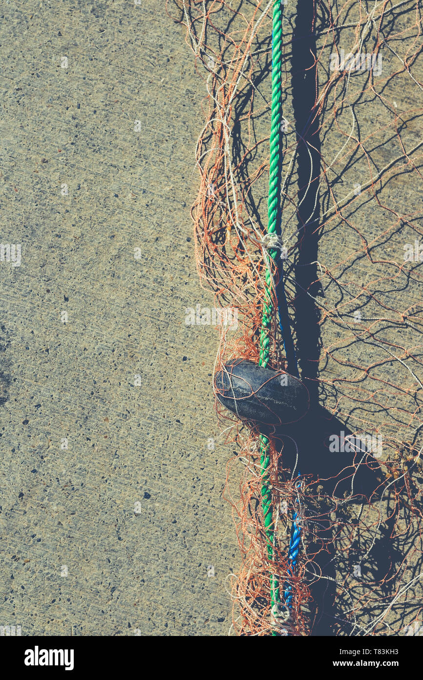 Fishnet with buoy on rope. Nautical marine background Stock Photo - Alamy