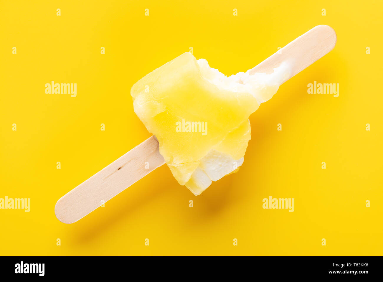 top view yellow popsicle with bites on a yellow background Stock Photo ...