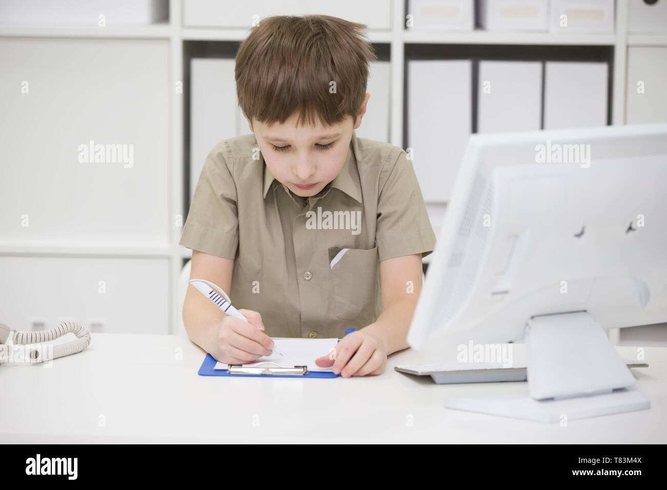 Junior school student doing homework Stock Photo - Alamy