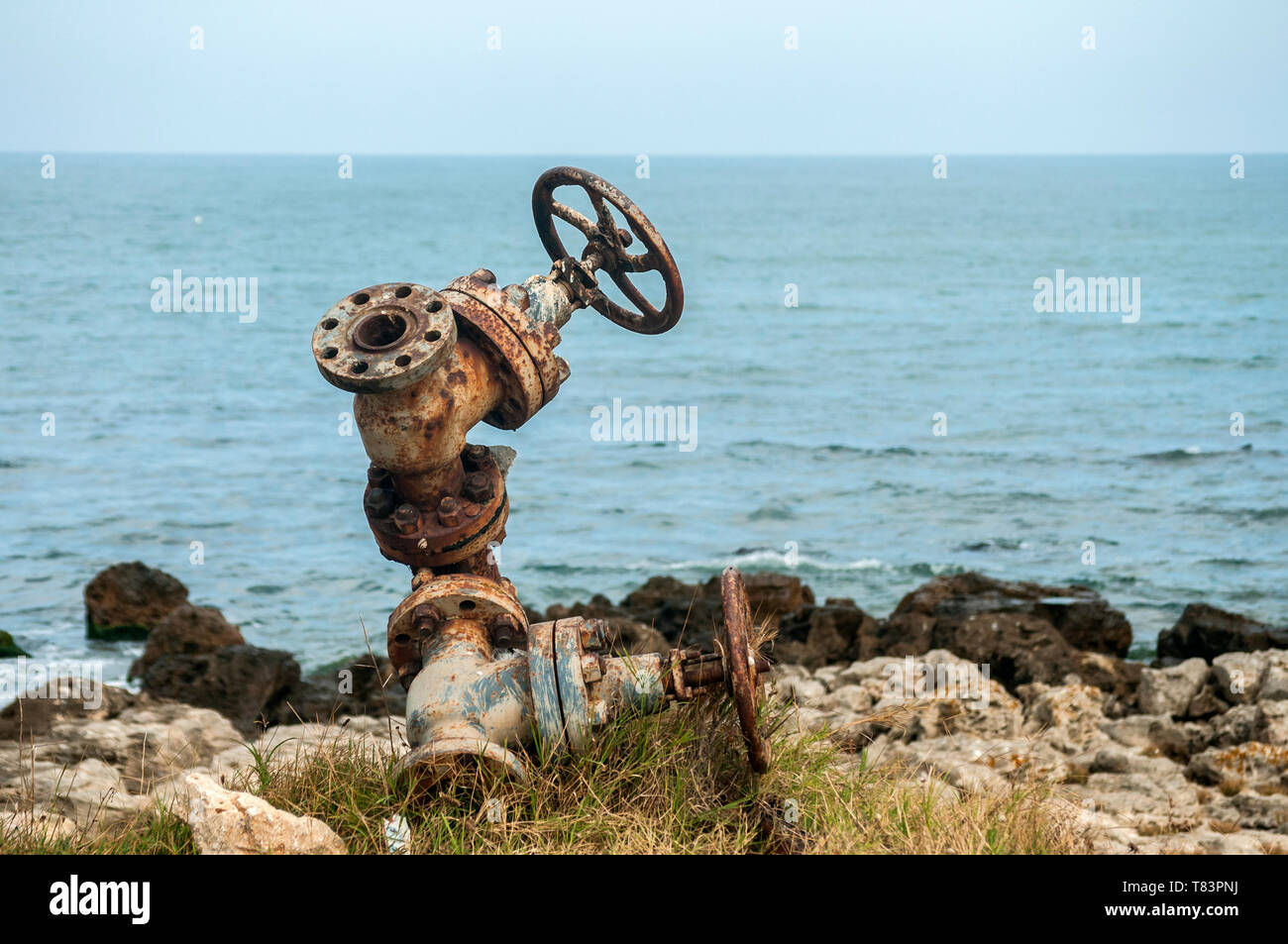 Old rusty weathered aged valve of abandoned pipe system equipment ...