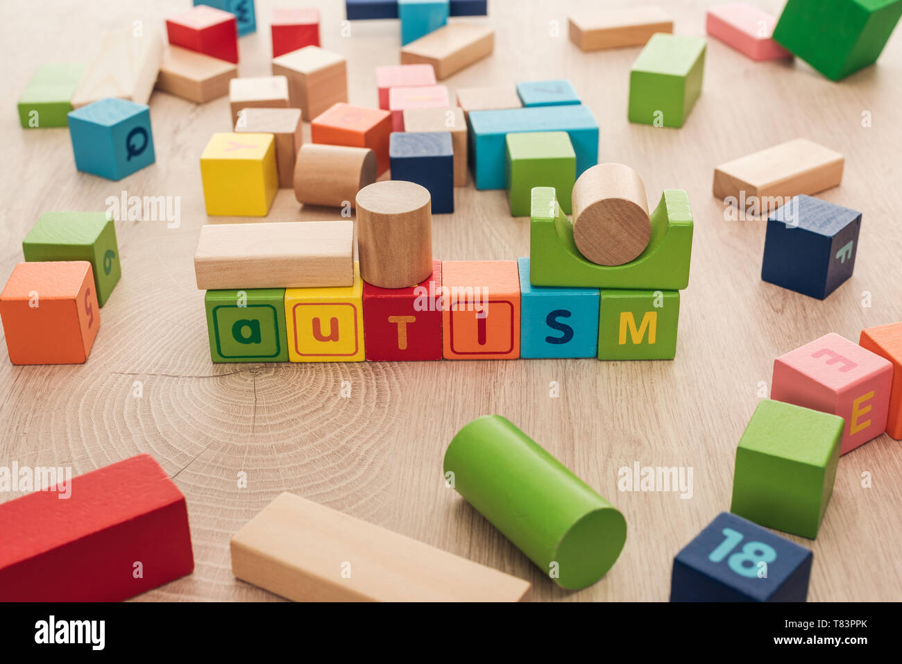 autism lettering made of multicolored cubes among building blocks on ...