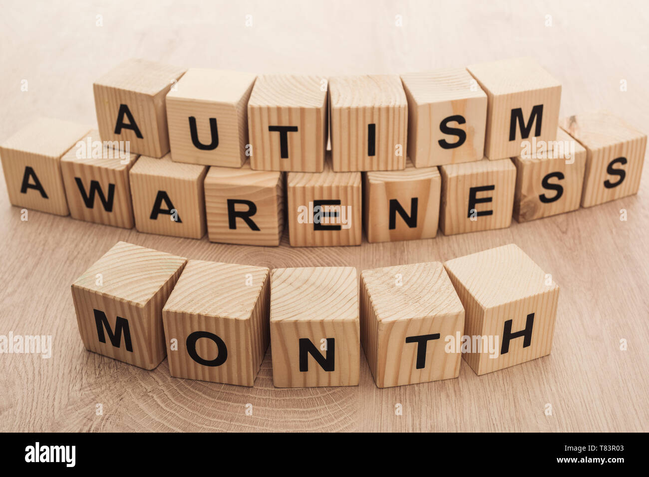 autism awareness month words made of wooden cubes Stock Photo - Alamy