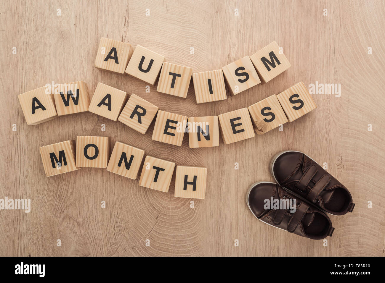 top view of autism awareness month words made of wooden blocks near ...