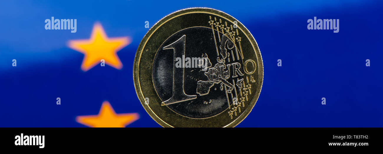 one euro coin on the background of the flag. Business concept. Web ...