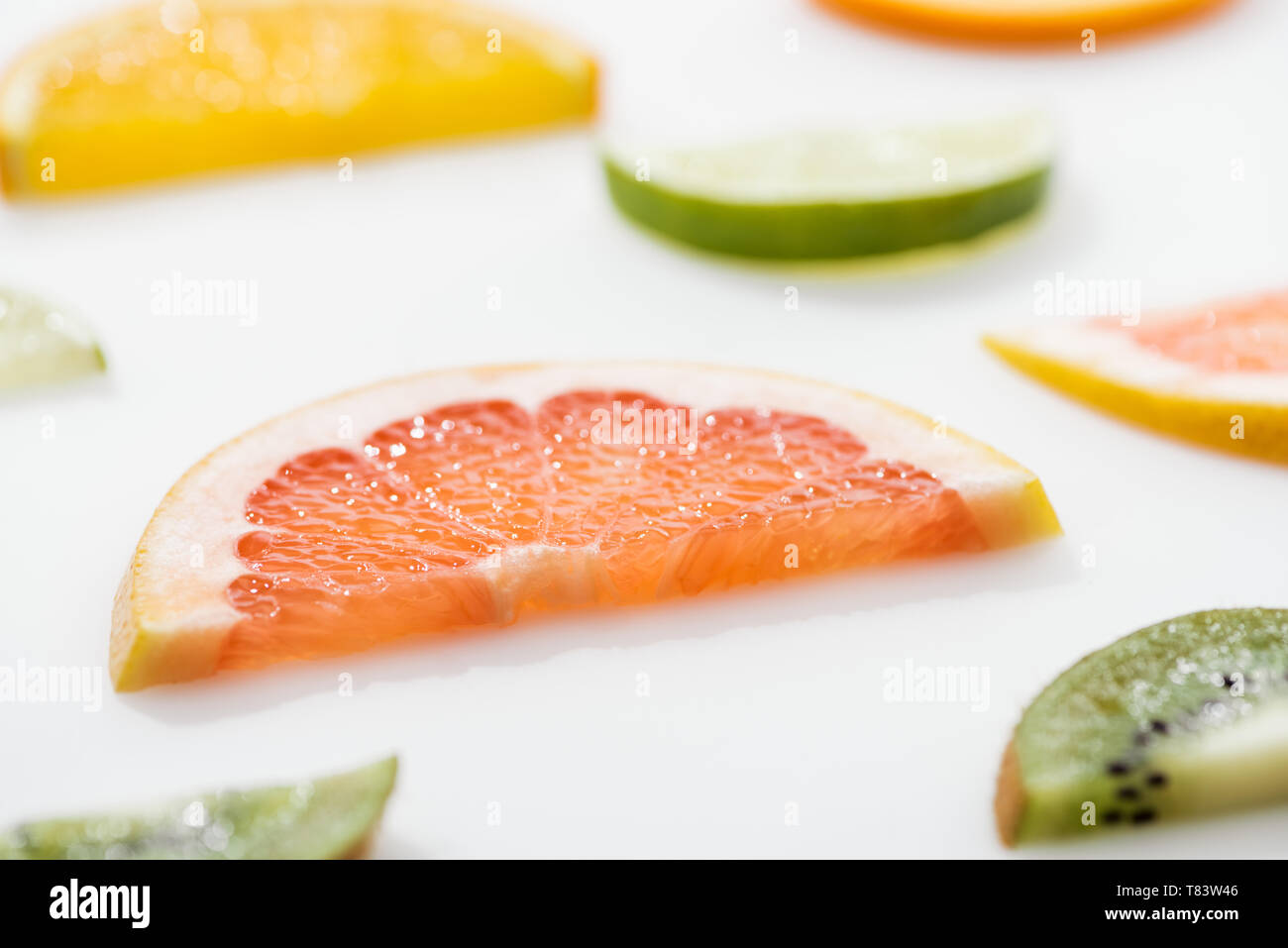 Juicy fresh sliced citrus fruits on white surface Stock Photo - Alamy