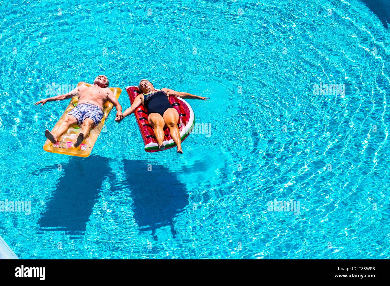 Total relax for happy mature senior retired people lay down on coloured ...
