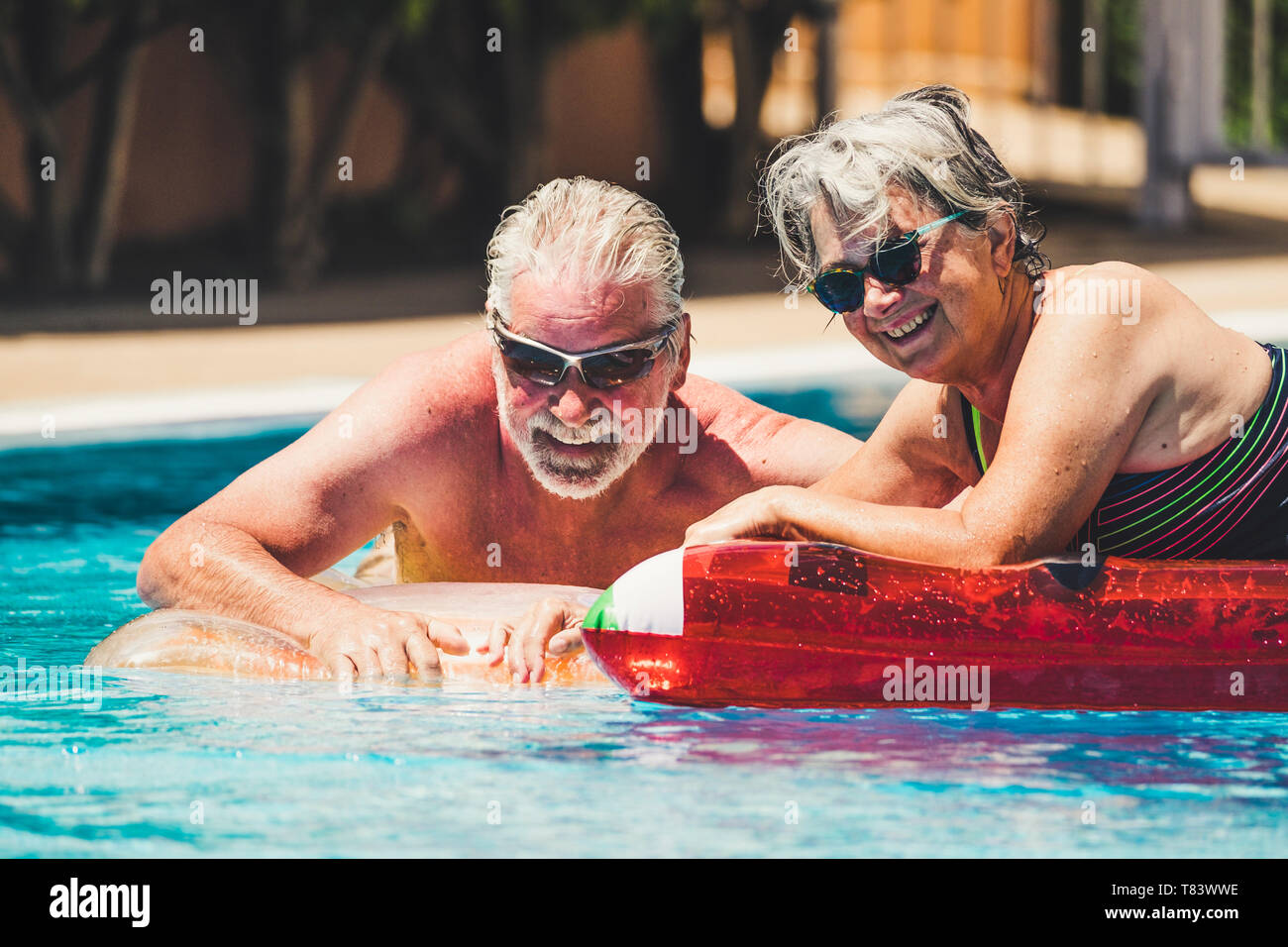 Happy joy cheerful people adult senior couple have fun in the swimming ...