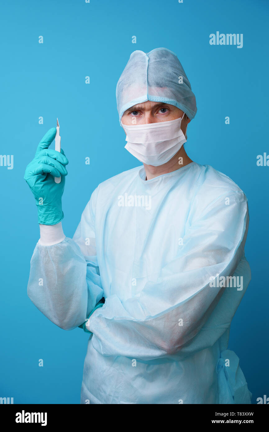 Surgeon in sterile blue uniform, medical gloves and mask Stock Photo ...