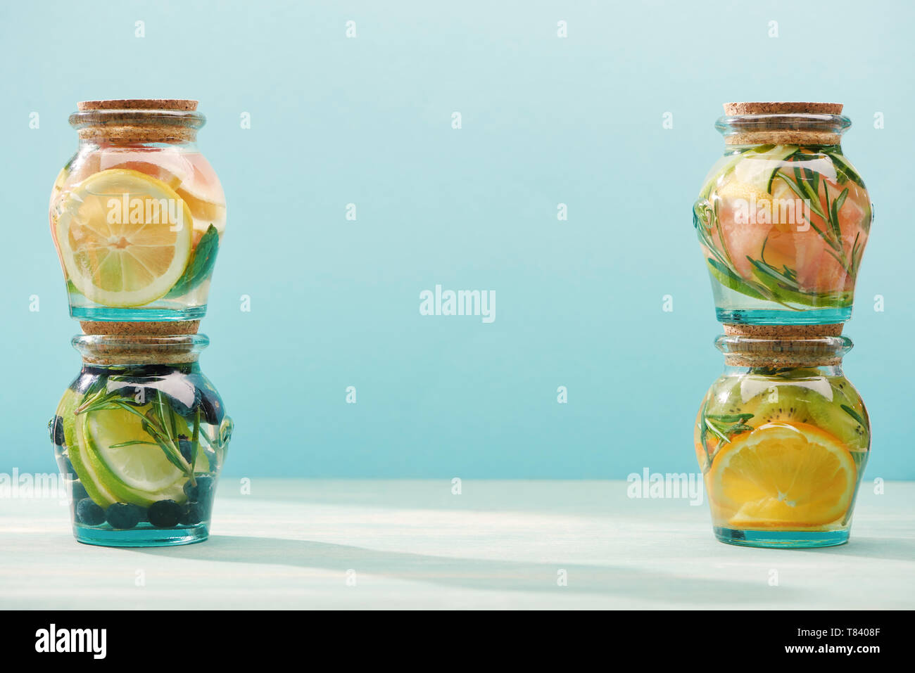 detox beverages in jars with fresh fruits isolated on blue Stock Photo ...