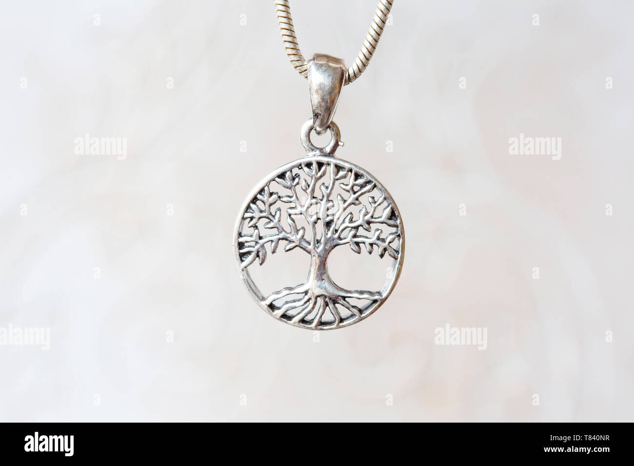 Silver tree in madala pendant on natural white background Stock Photo ...