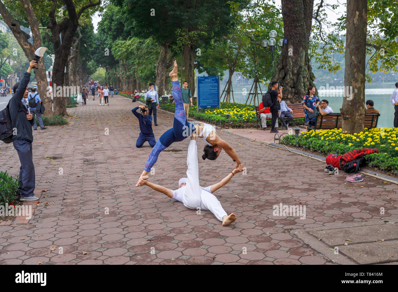 A young couple perform acrobatics on the pavement on the side of Hoan ...